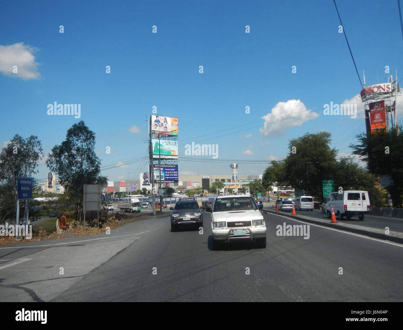 This image showcases a stretch of the Olongapo-Gapan Road in Pampanga ...