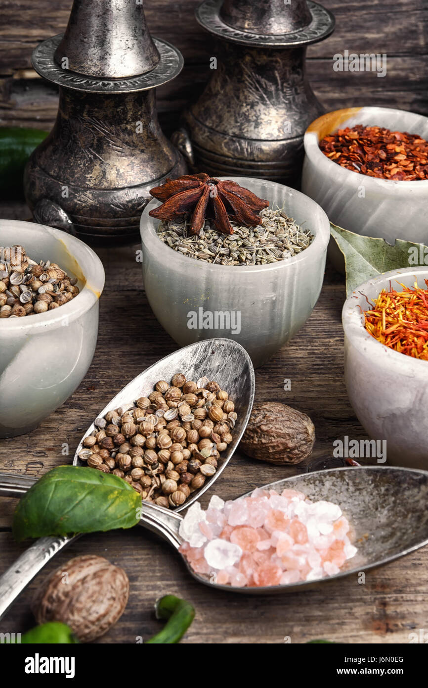set of aromatic Indian spices and condiments on wooden retro background ...