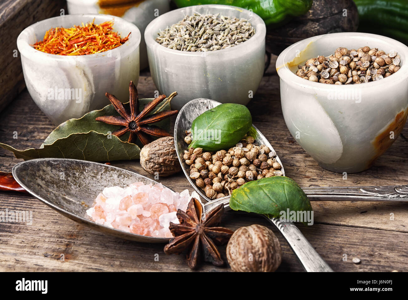 set of aromatic Indian spices and condiments on wooden retro background ...