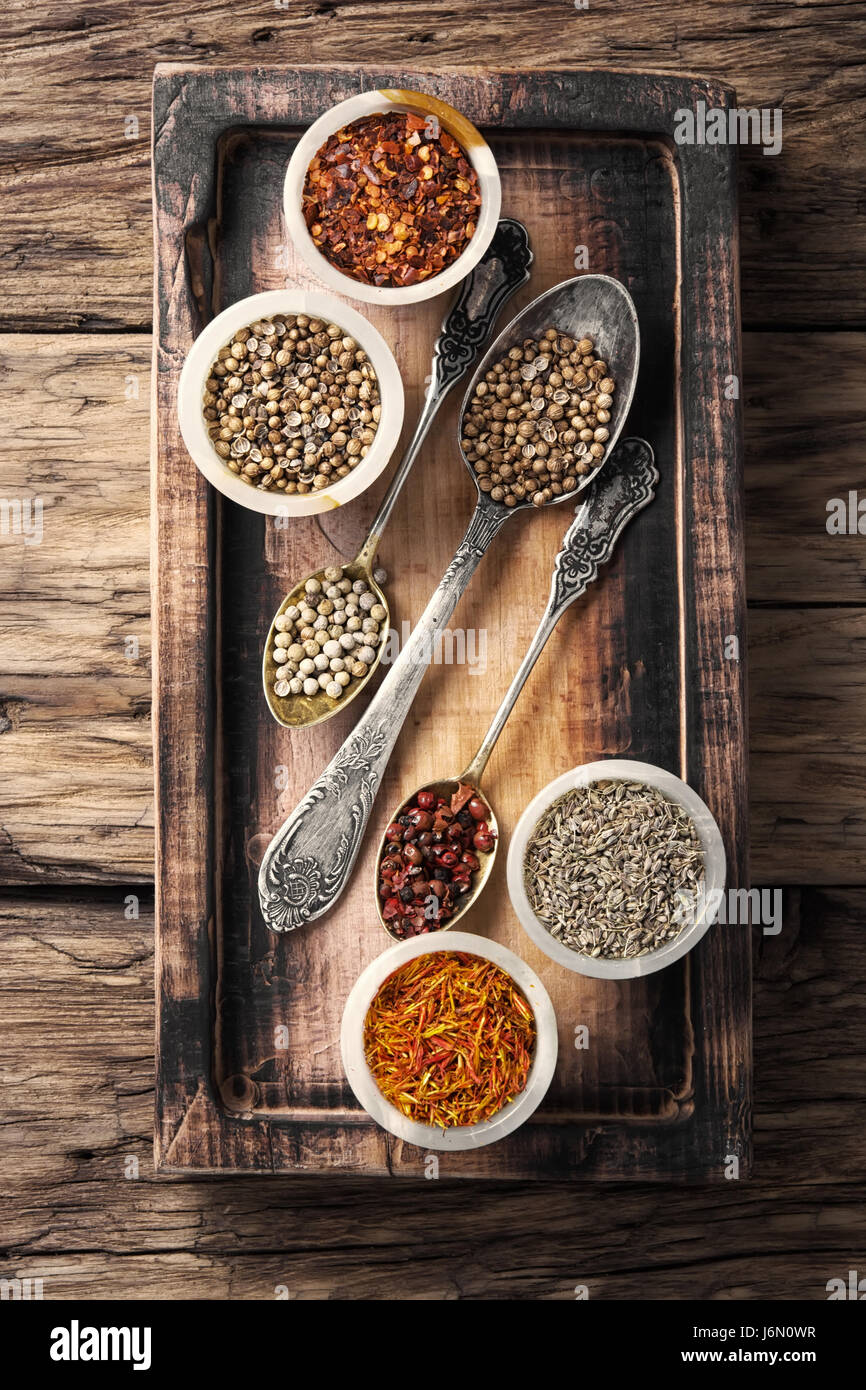 set of aromatic Indian spices and condiments on wooden retro background ...