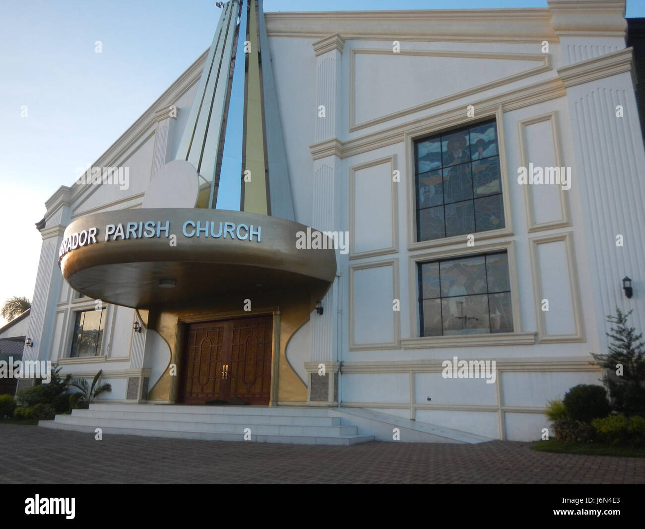 This image shows the exterior of the San Isidro Labrador Parish Church ...
