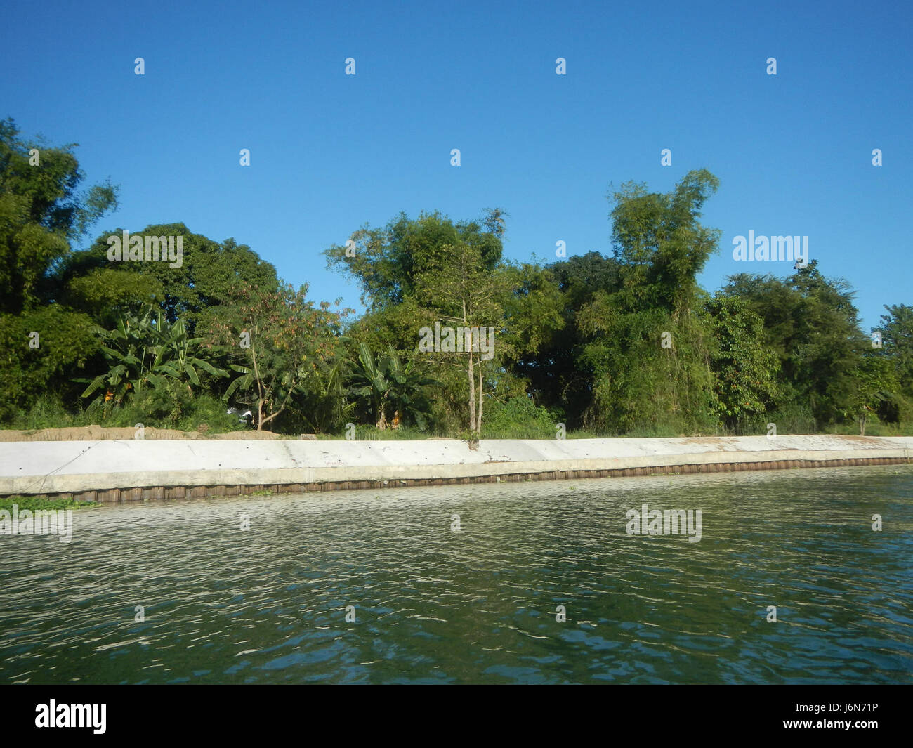 This photo showcases the construction of a riprap along the riverbanks ...