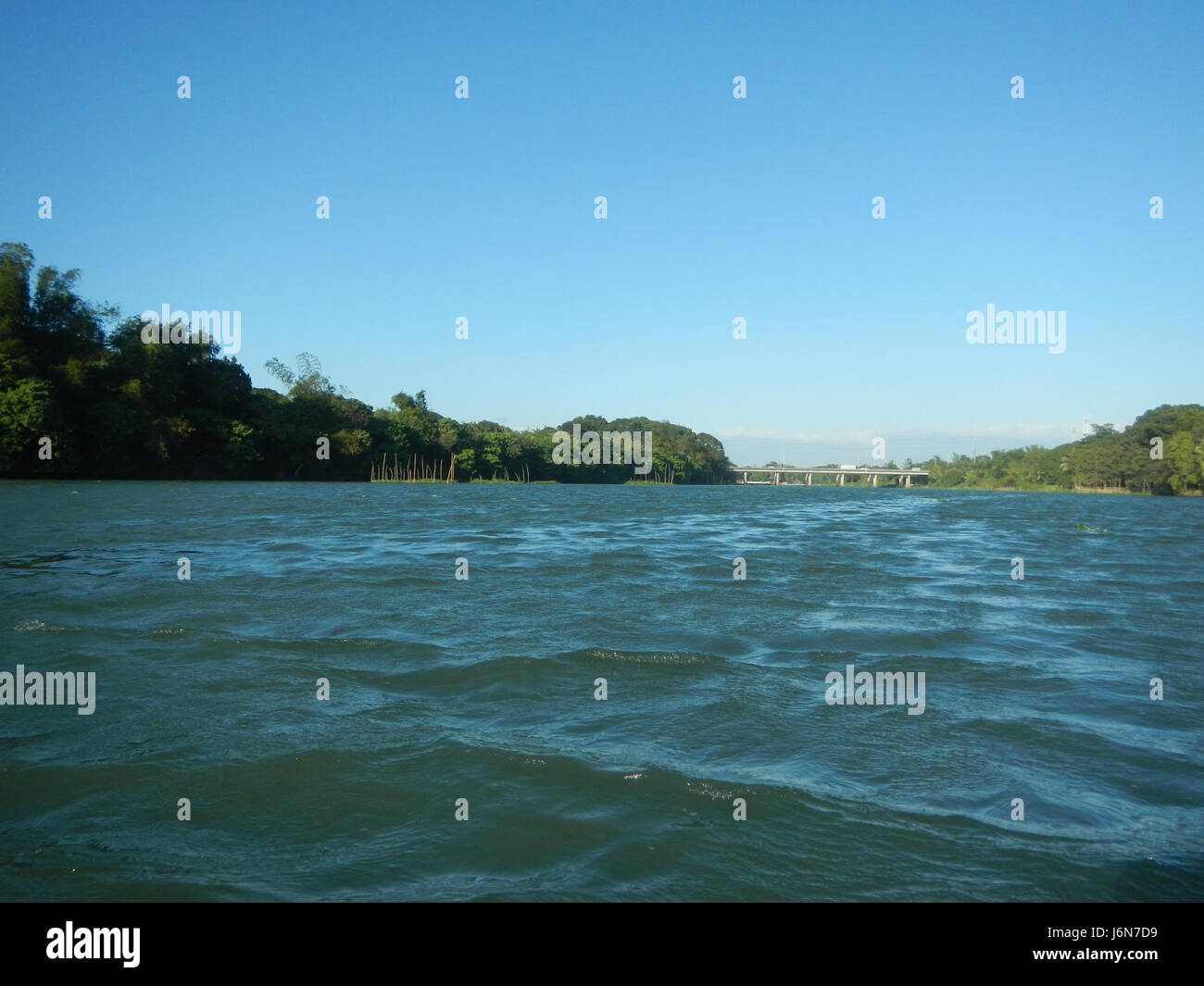 The image depicts the riprap construction along the riverbanks near the ...
