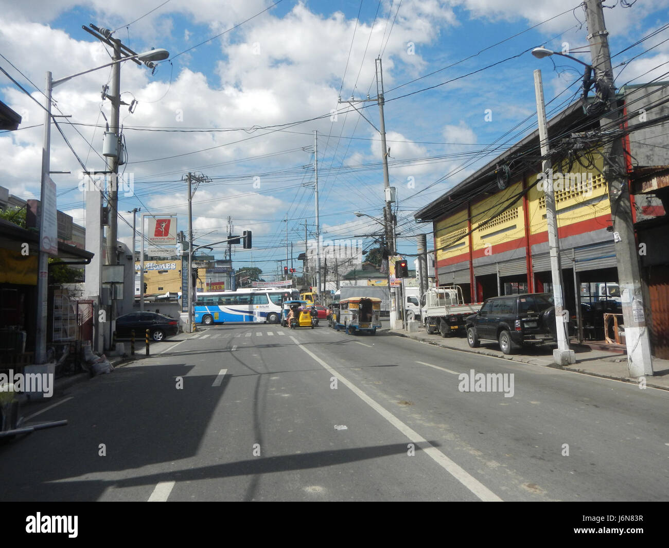 This image shows A. Mabini Street in Caloocan City, Philippines, with a ...