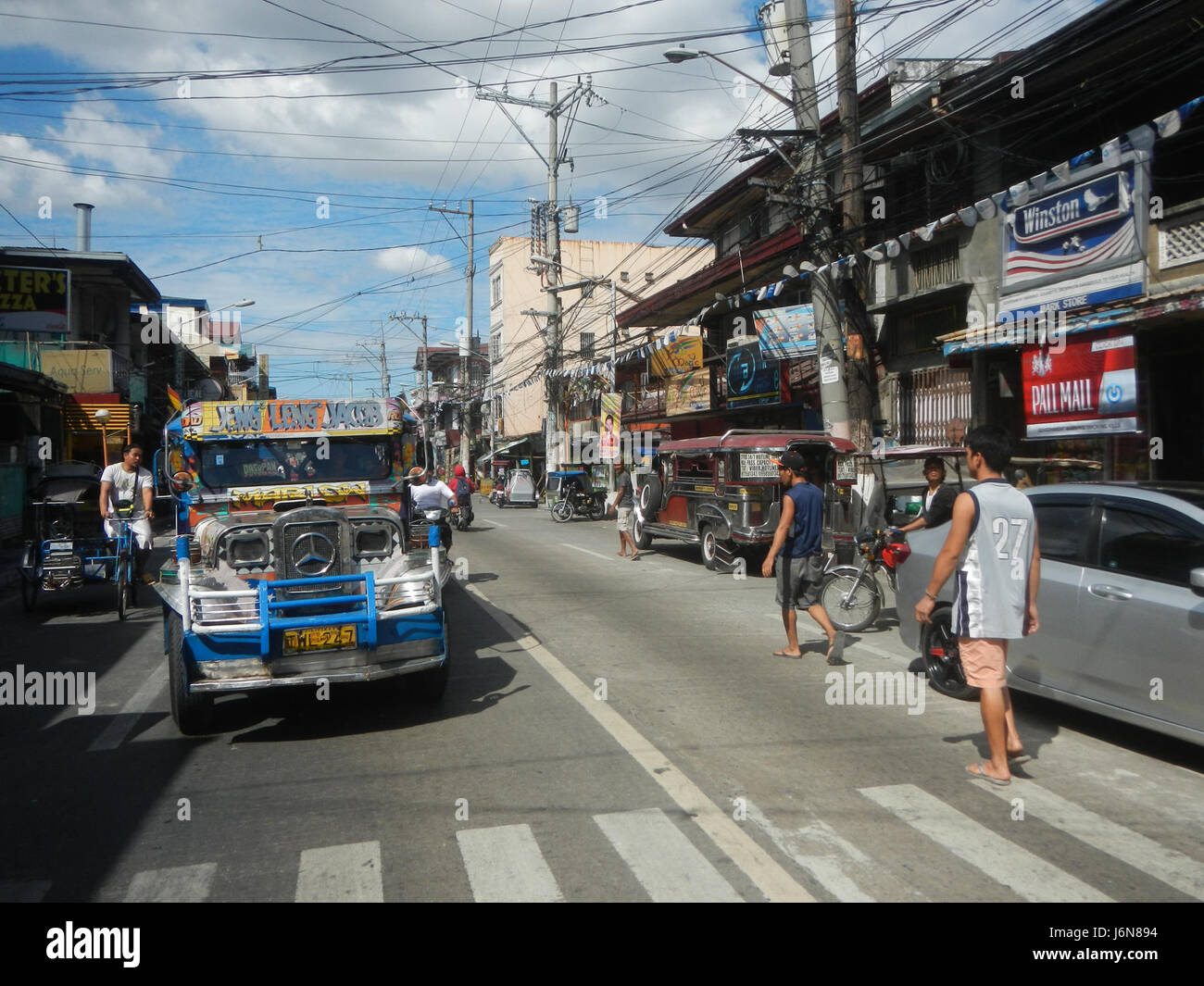 This image depicts A. Mabini Street in Caloocan City, with the Martinez ...