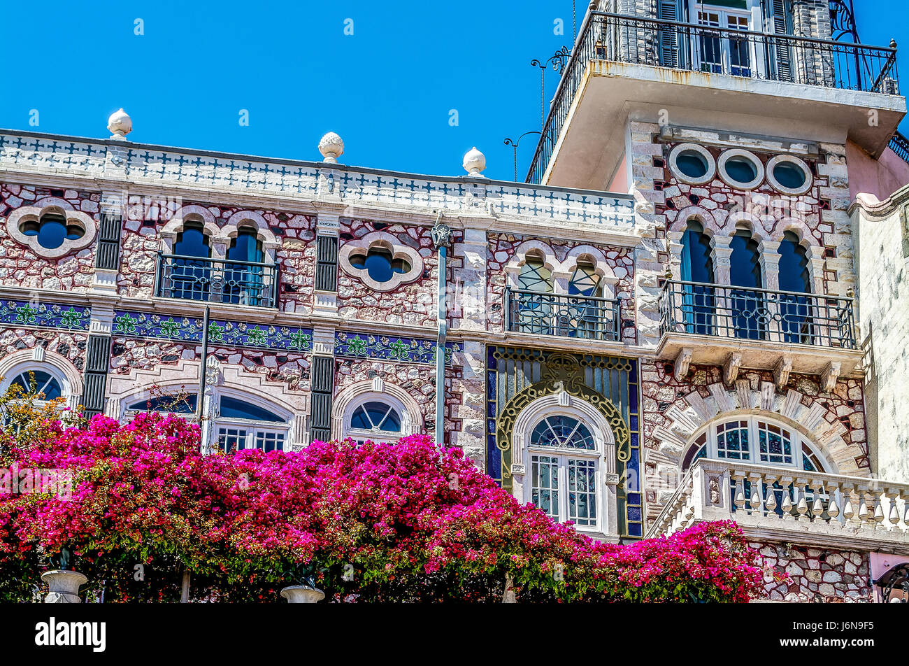 Cute historic building with flowers on the second floor Stock Photo - Alamy