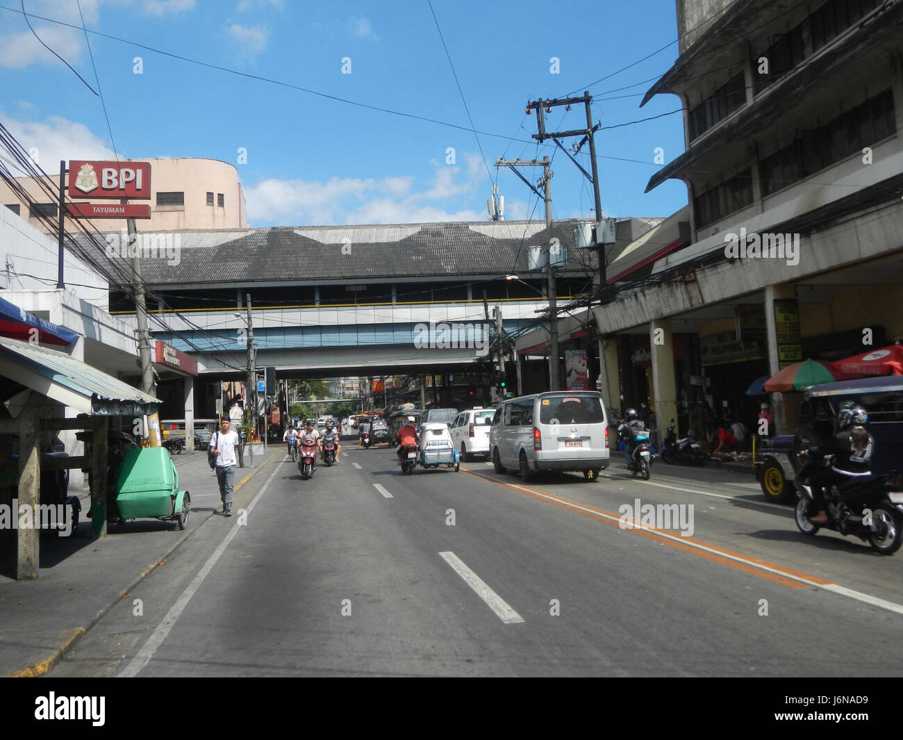 This photograph depicts Tayuman Street in Santa Cruz, Tondo, Manila. The image captures urban ...