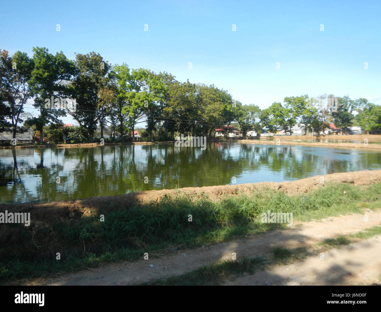 This image depicts fish ponds in the Malamig region of Bustos, Bulacan ...