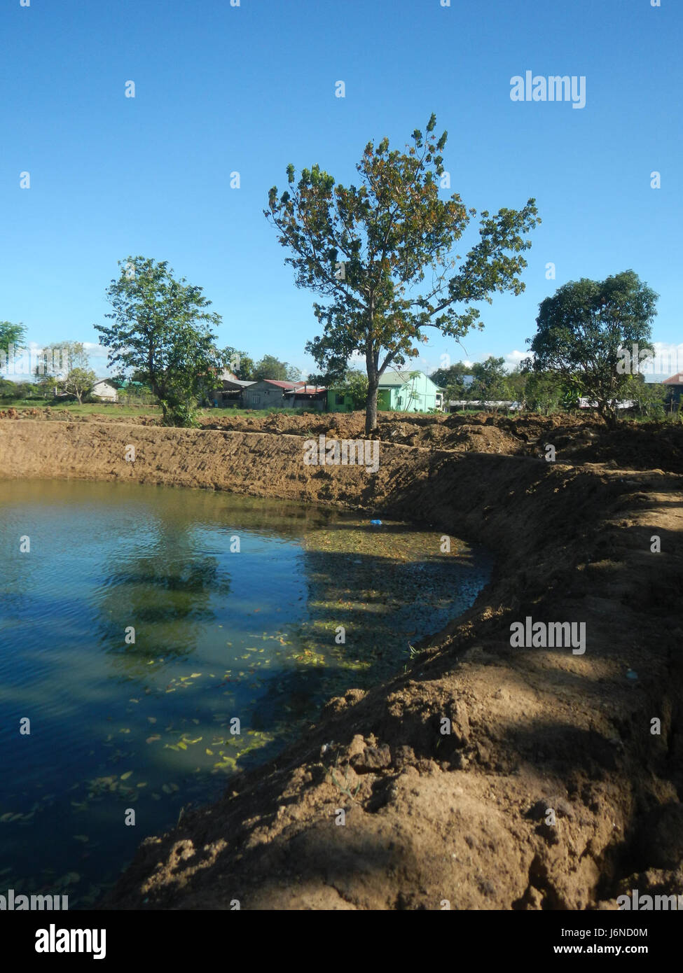 A photograph of fish ponds located in Malamig, Bustos, Bulacan, showing ...