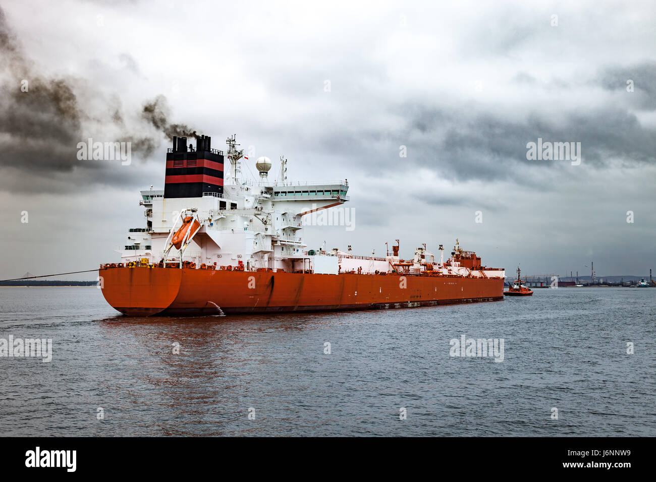 Tug boat towing a tanker ship at sea Stock Photo - Alamy