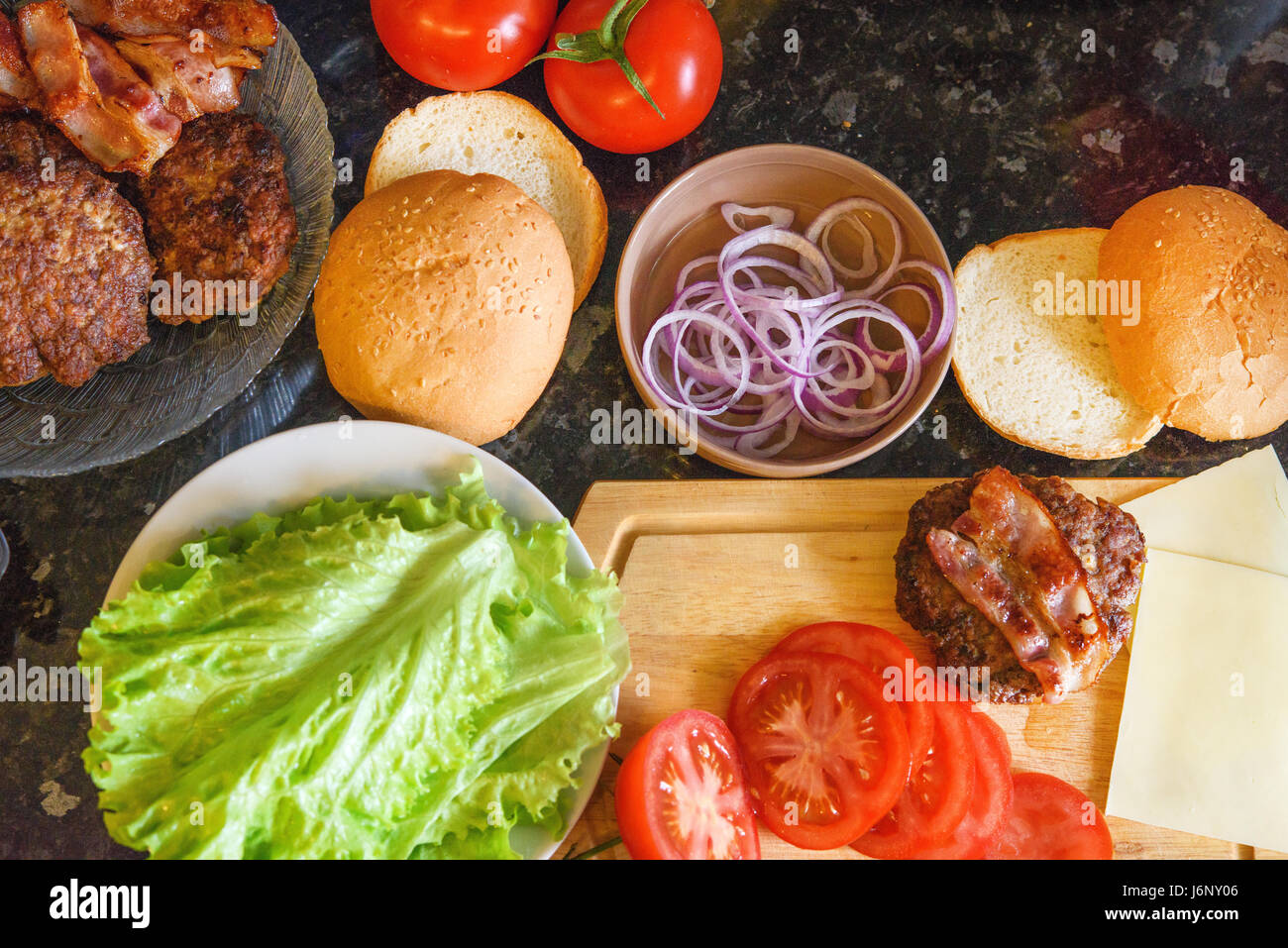 Homemade burger ingredients: burger cutlet, lettuce, tomato, buns ...