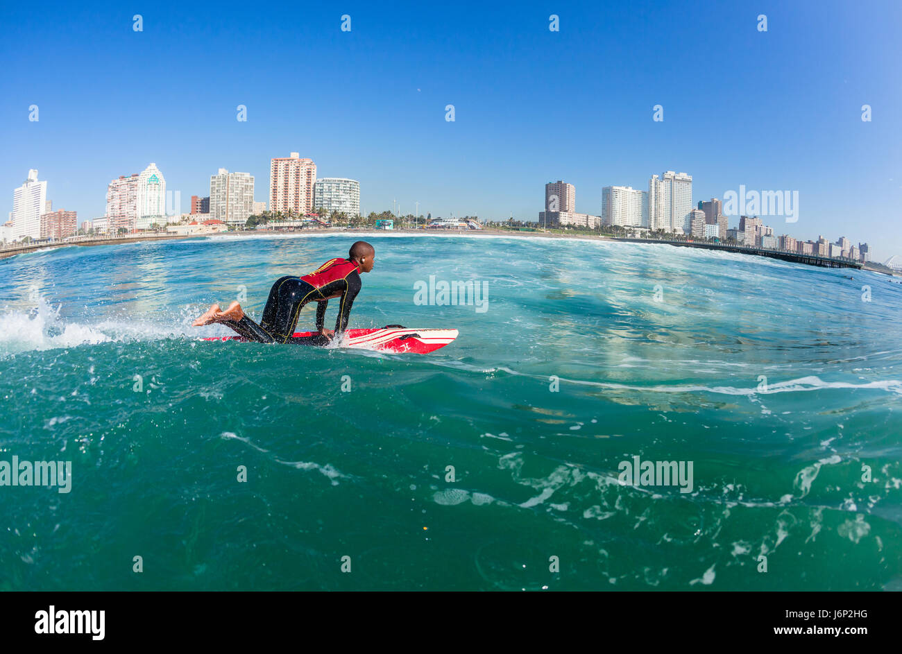 Surfing lifeguard on the rescue paddle ski closeup water action North ...