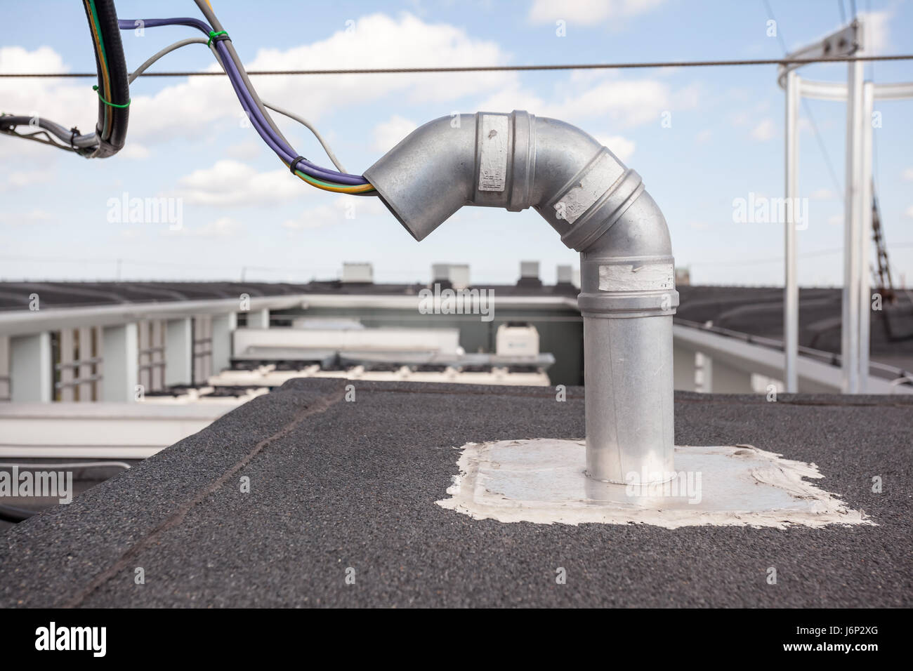 Metal pipe from the flat roof where electrical cables come through ...