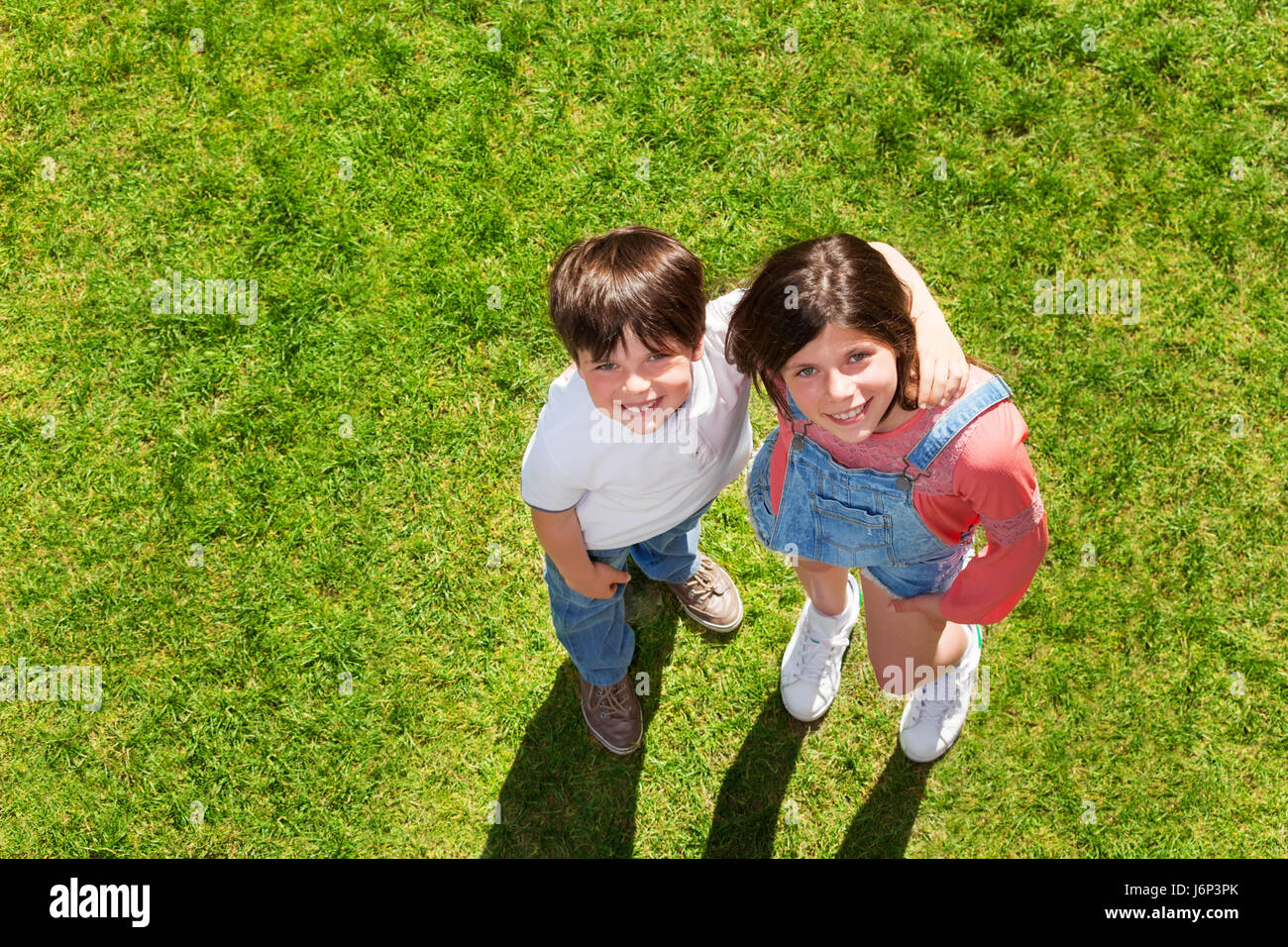 Top view portrait of happy kids standing on the lawn and hugging Stock ...