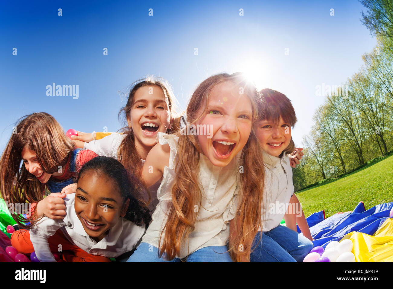 Big group of cute kids hugging and laughing during outdoors party in ...