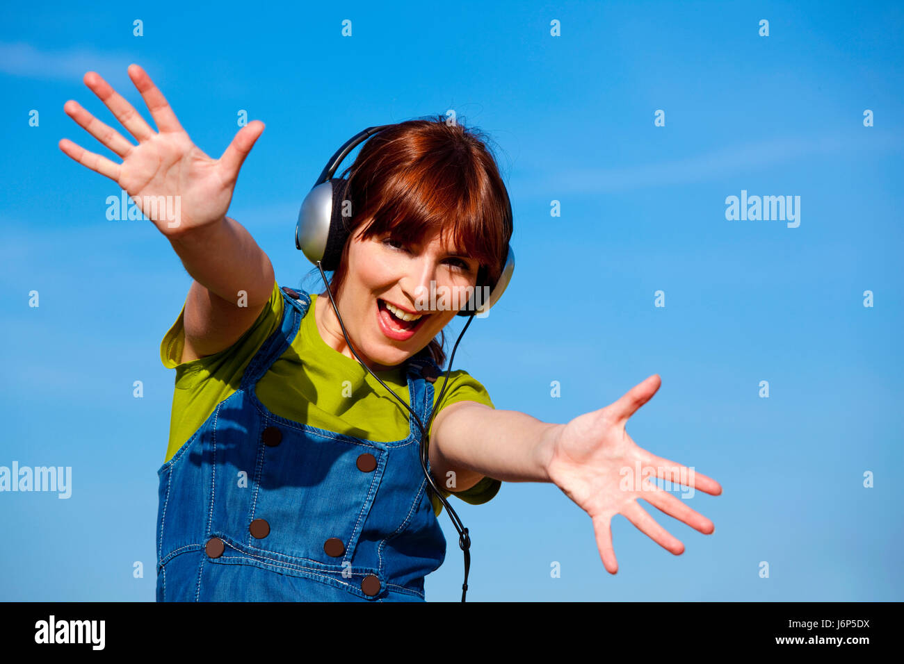 woman listen music spring bouncing bounces hop skipping frisks jumping ...