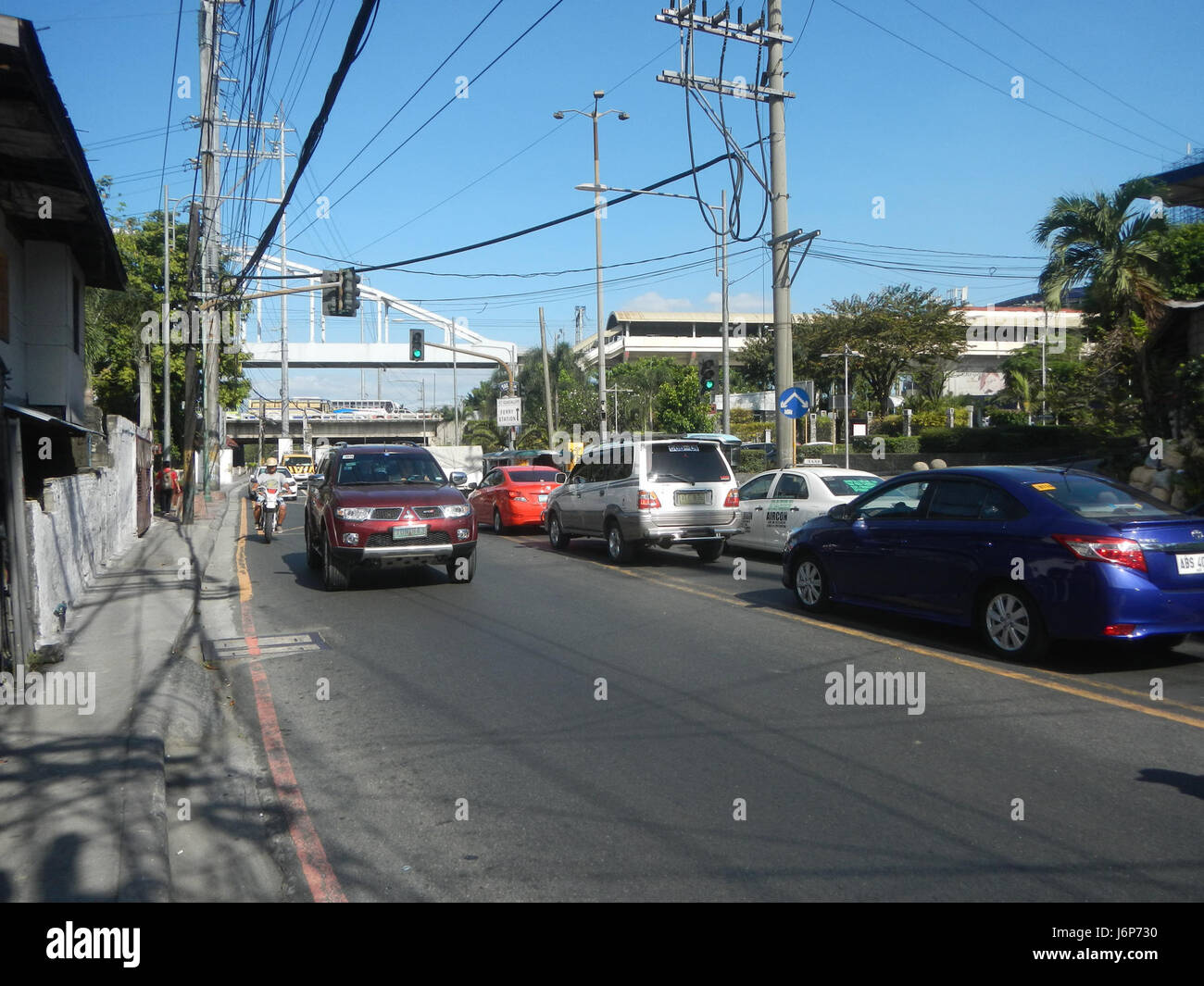 This image shows J.P. Rizal Avenue in Valenzuela, a busy urban road in ...