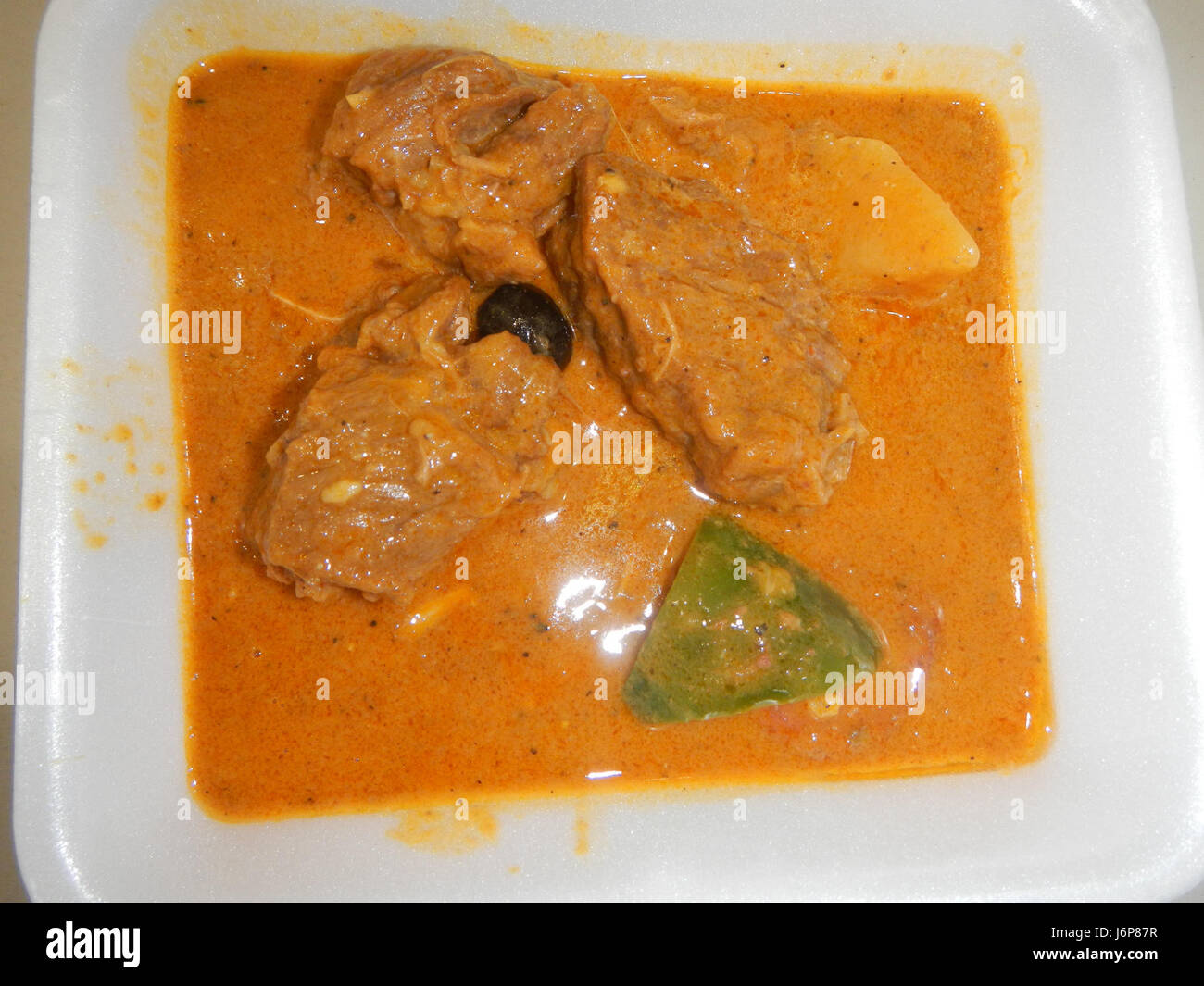 This image showcases a traditional Filipino dish, Caldereta, a stew ...
