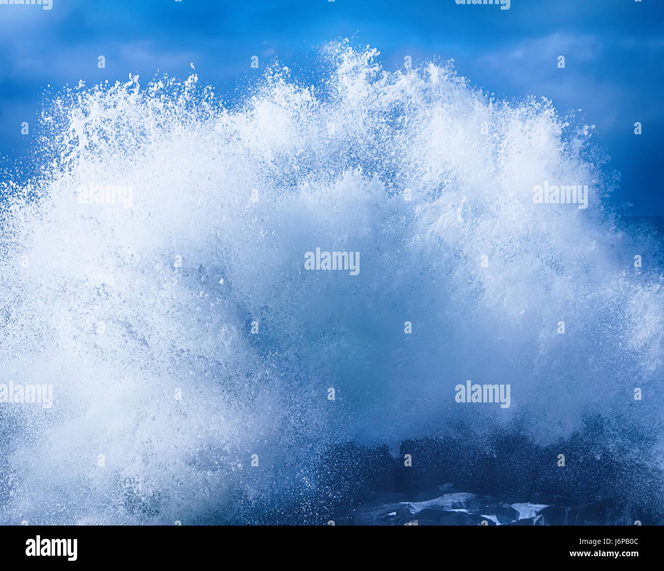 Impressive storm on Pacific coast. Wind blows spray from wave crest ...