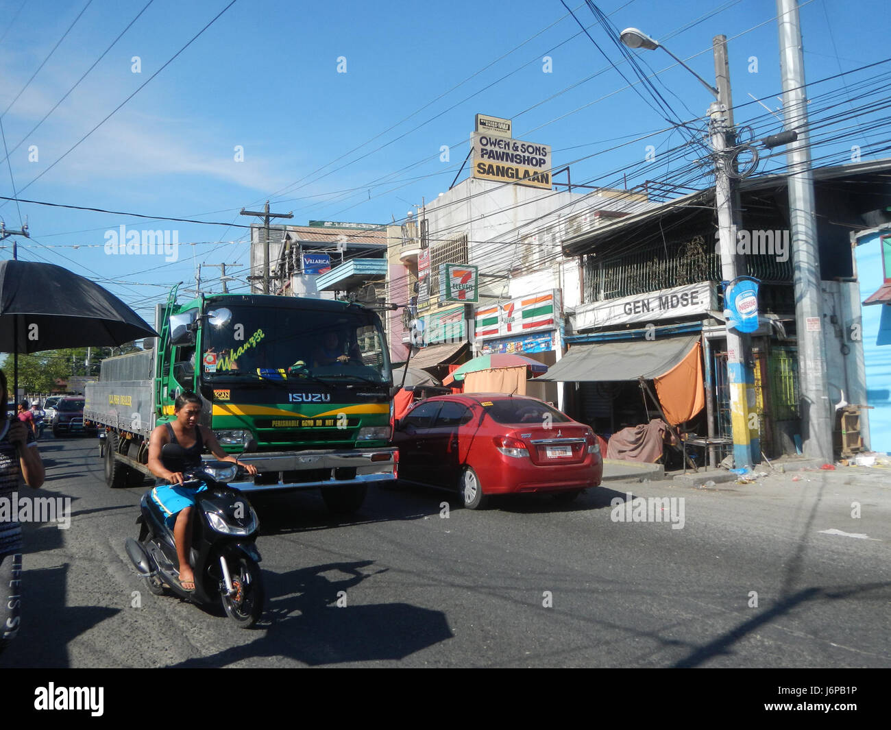 This photograph captures the urban scene along C. Dizon Avenue in San ...