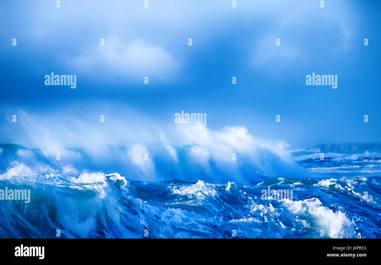 Impressive storm on Pacific coast. Wind blows spray from wave crest ...