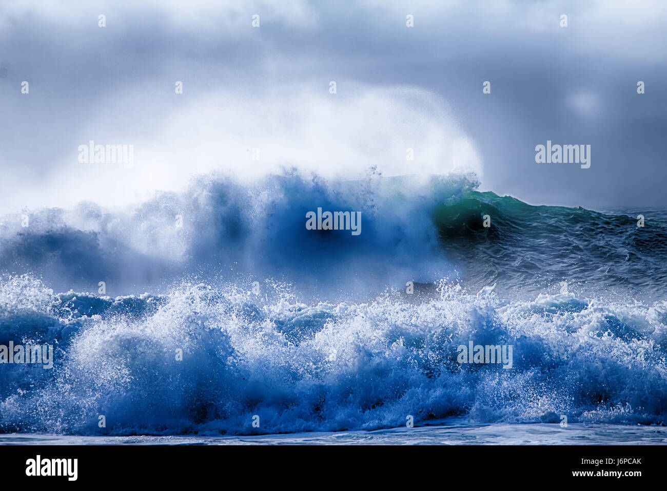 Impressive storm on Pacific coast. Wind blows spray from wave crest ...