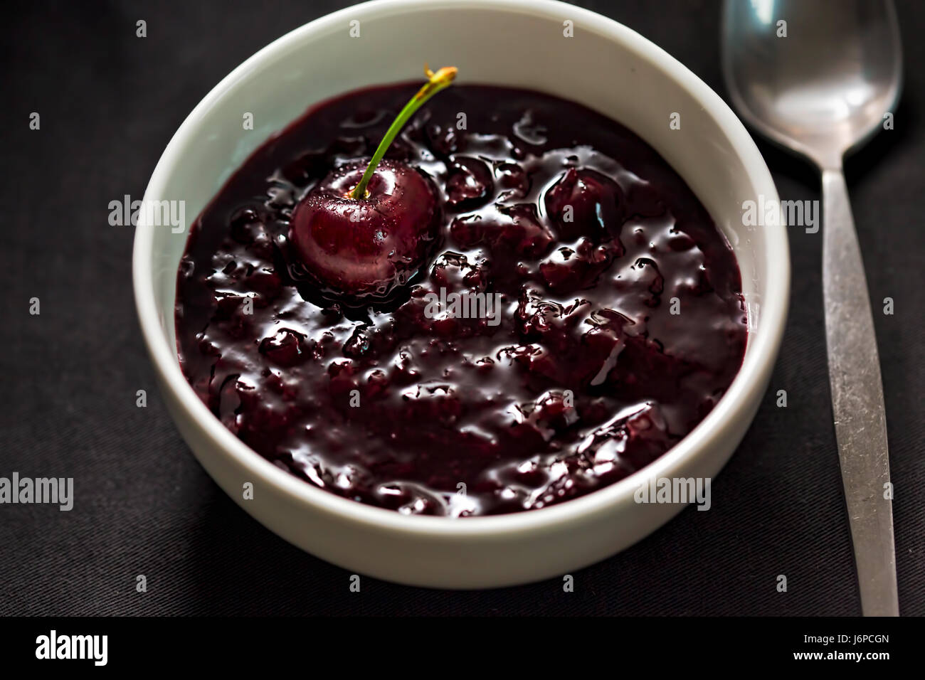 Cherry compote with cherry on top Stock Photo - Alamy
