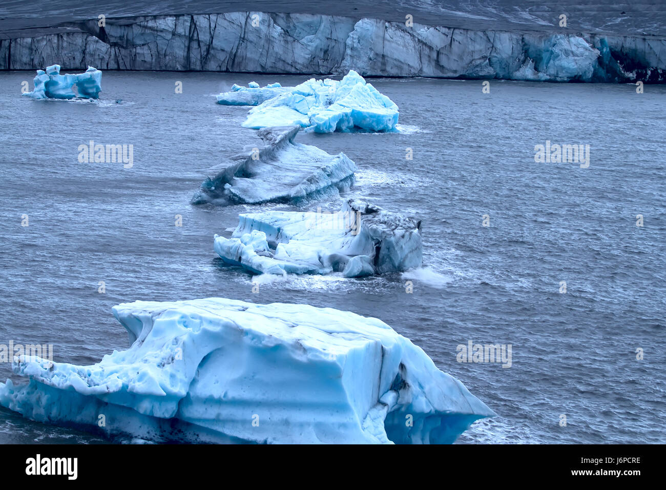 harsh glaciers of Arctic. Glacier ice formed in dead water of shallows ...