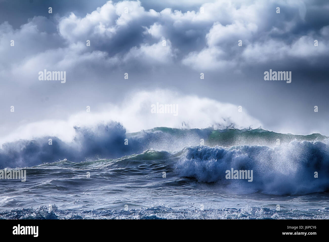 Impressive storm on Pacific coast. Wind blows spray from wave crest ...