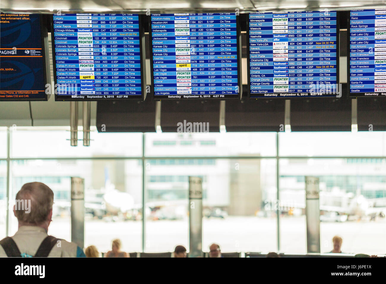 Checking flight status at Denver airport Stock Photo - Alamy