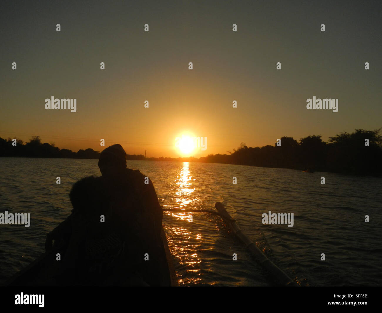 This image captures a serene sunset over the riverside districts of ...