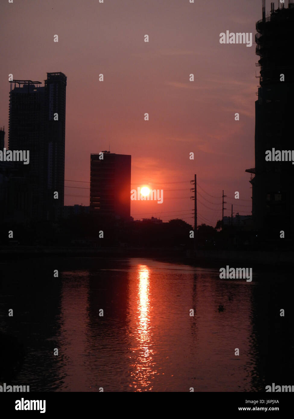 This photograph captures a beautiful sunset over the skyline of Makati ...
