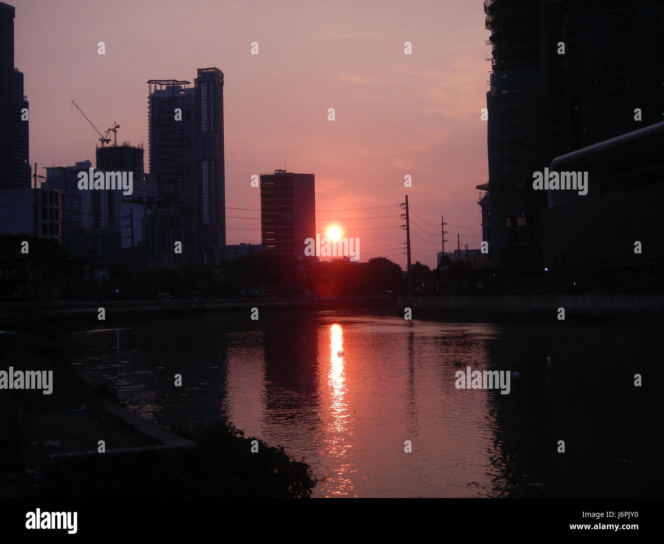 This image captures a sunset view over Makati and Mandaluyong City in ...