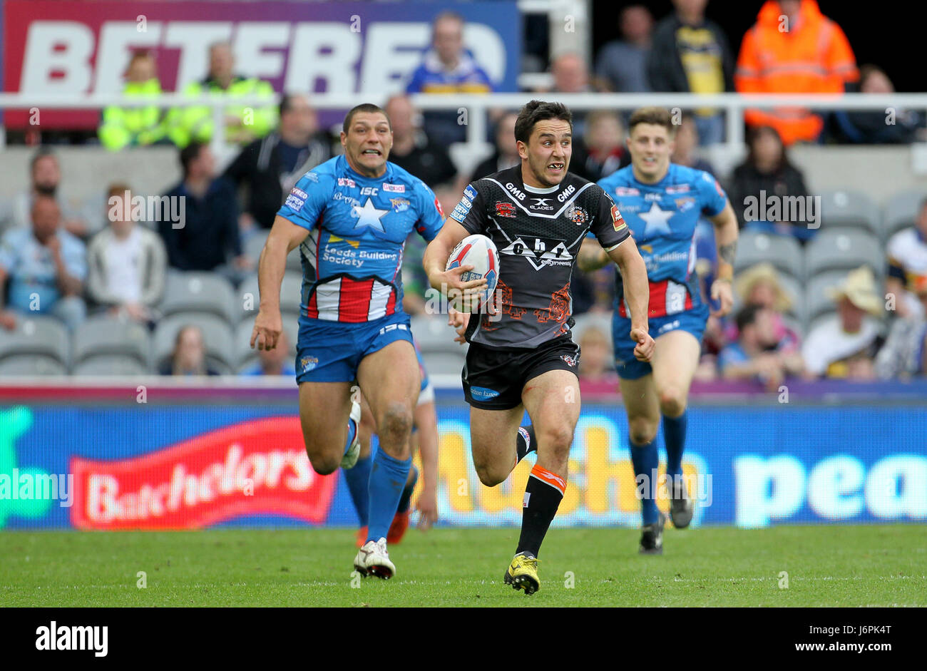 Castleford Tigers' Tom Holmes runs the length of the pitch to score a ...