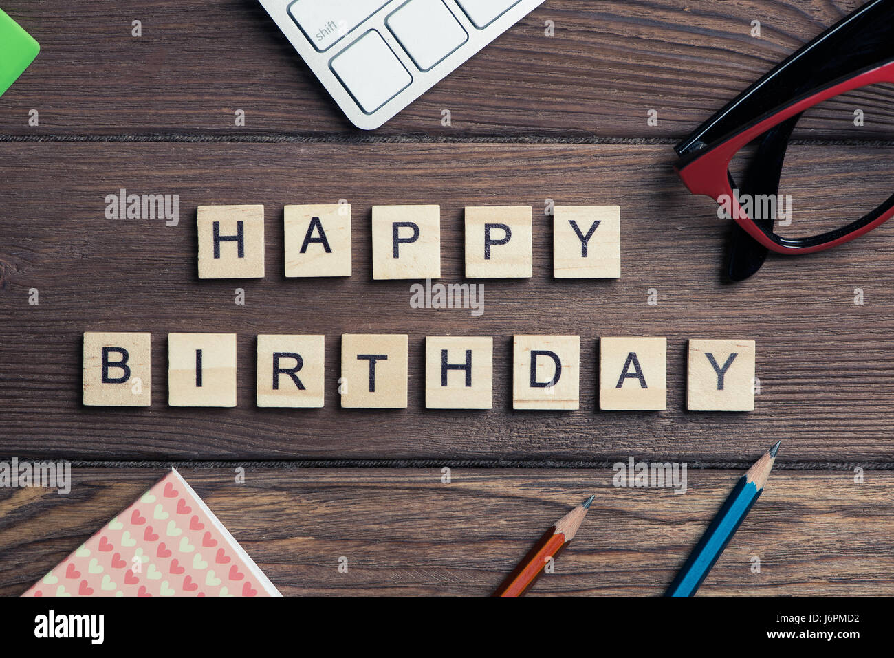 Office stuff and wooden cubes on workplace table making Happy Bi Stock ...