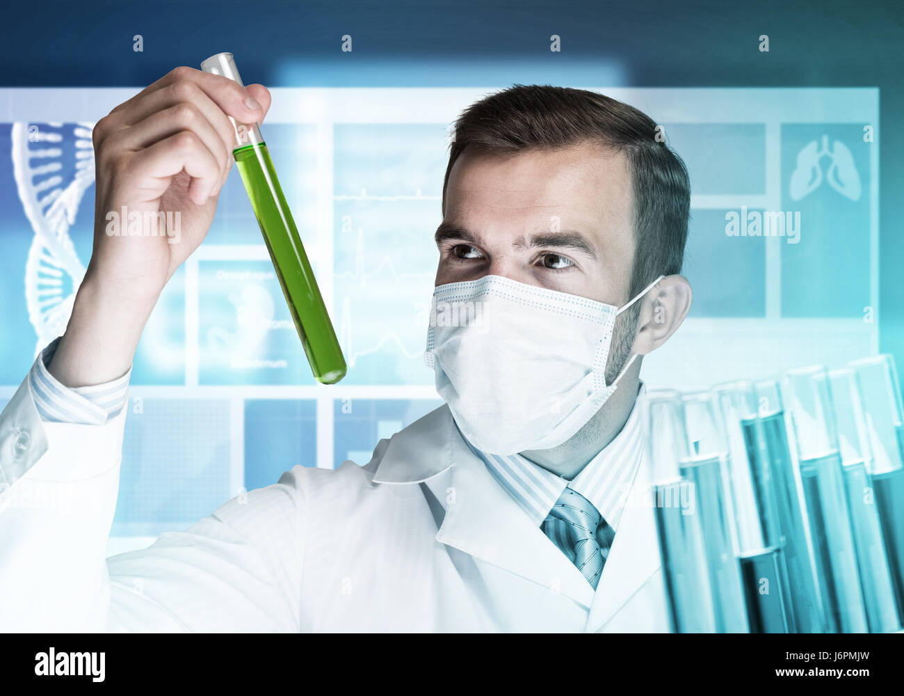 Portrait of concentrated male scientist working with reagents in ...