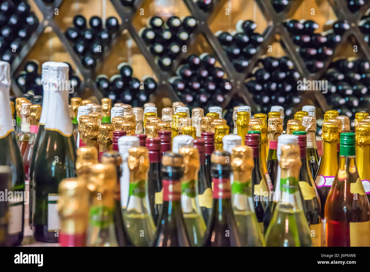 Bottle of champagne wine abstraction backdrop. Blurred alcohol bottles ...
