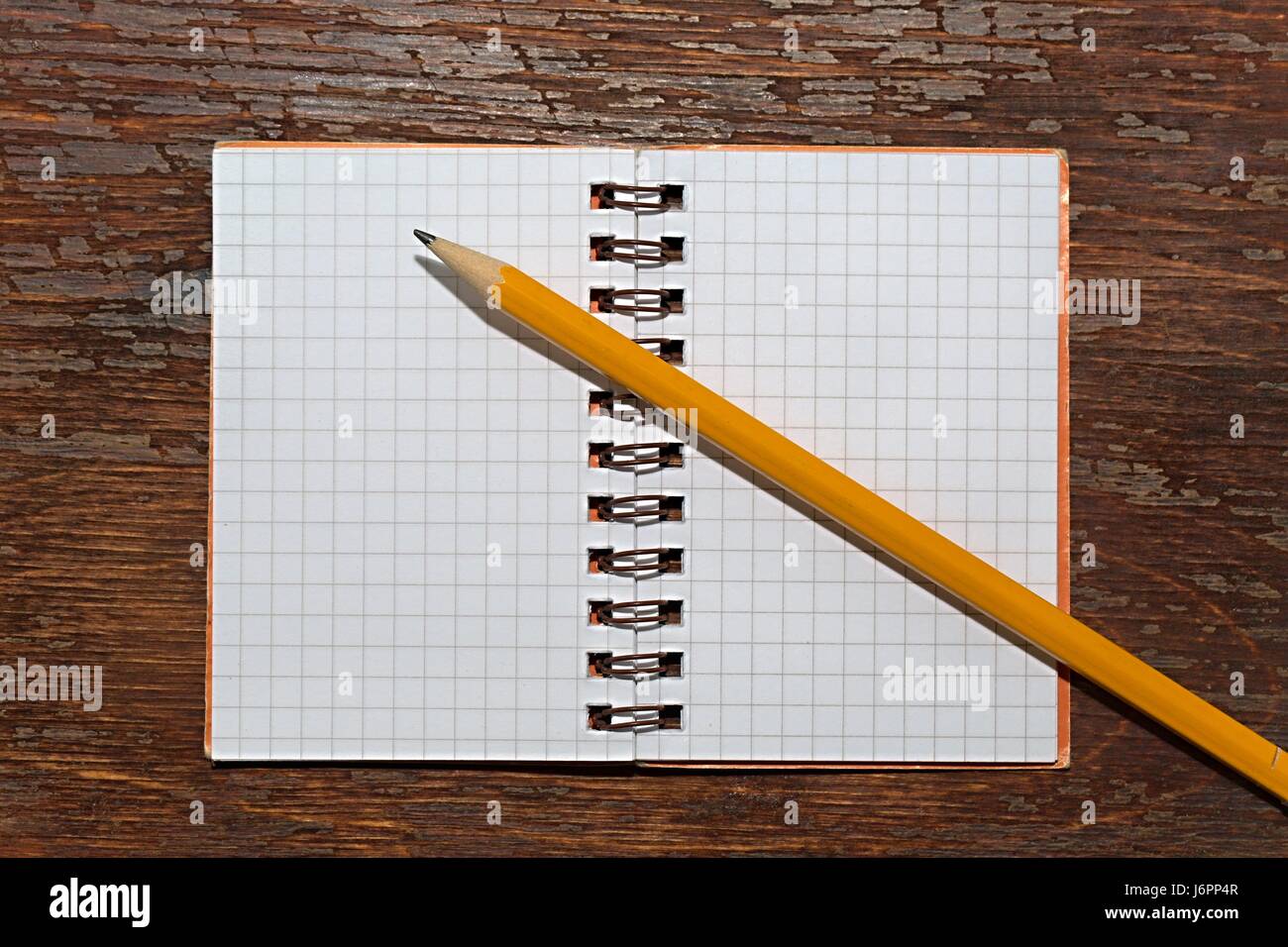 Notebook with square grid on a table Stock Photo - Alamy