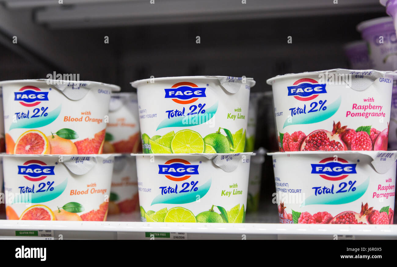 cartons of Fage brand fruit yogurt on the shelf of the refrigerator ...