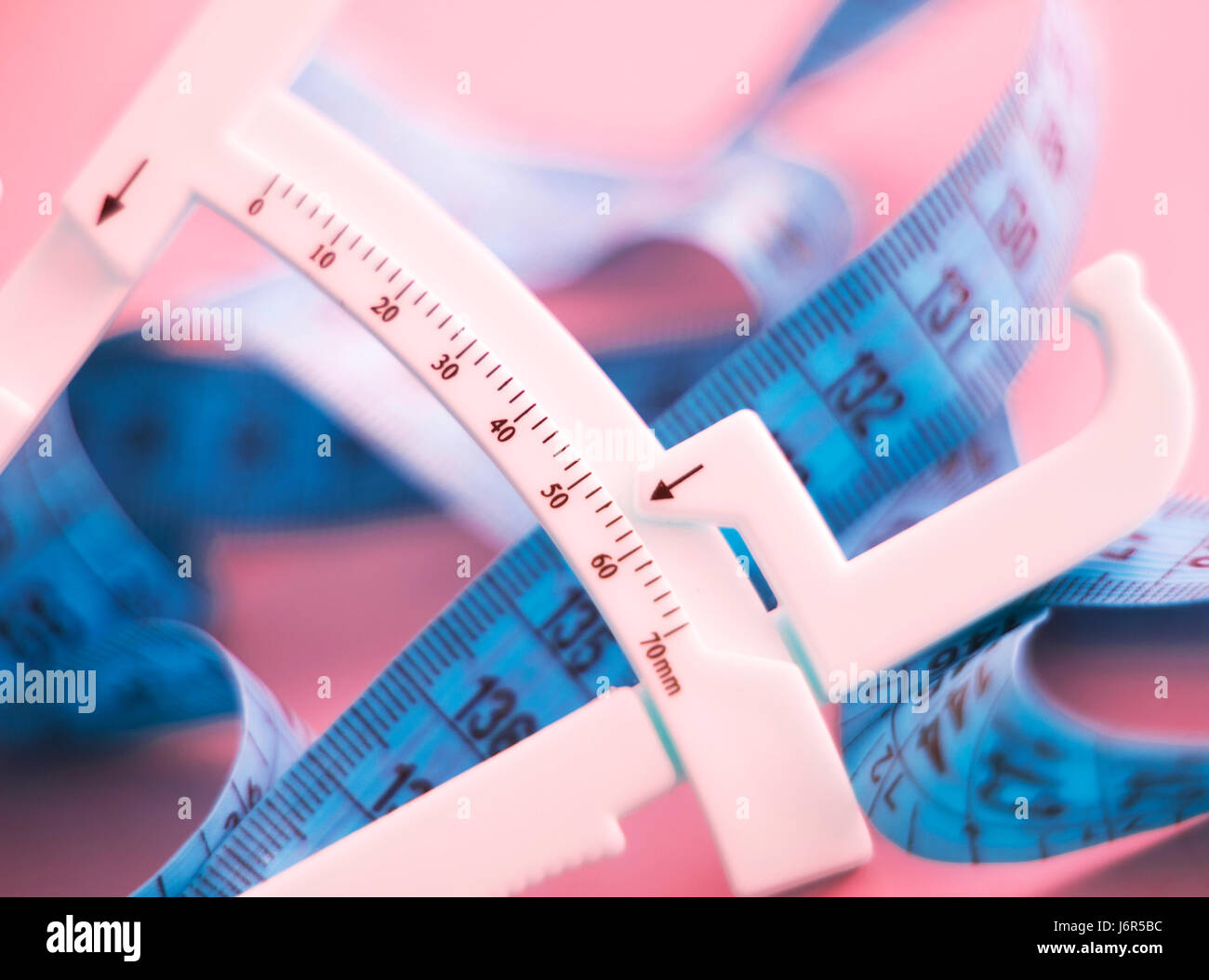 Fat caliper and measuring tape used to measure waistline, bodyfat ...