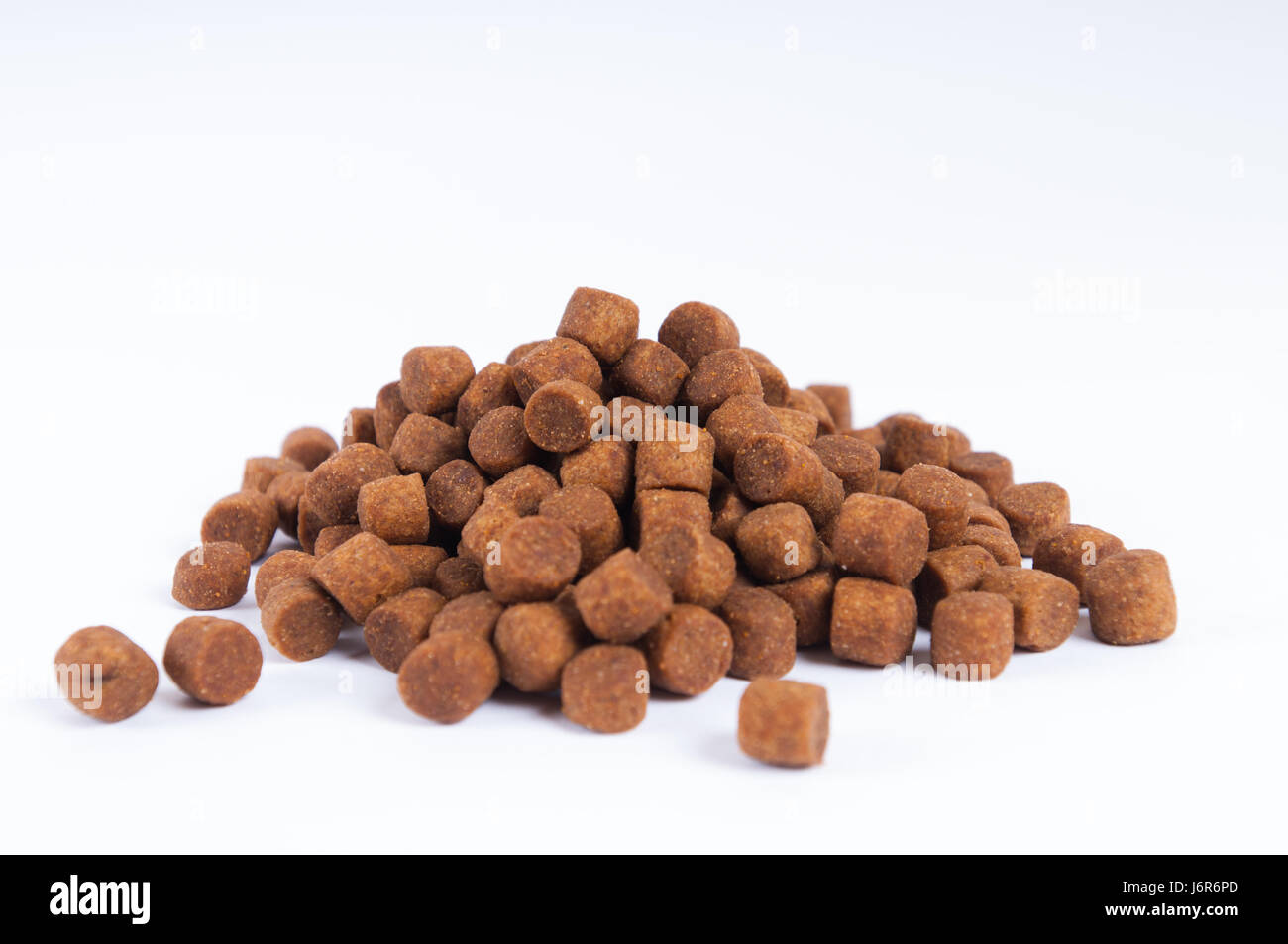 Dry dog food granules isolated on white background Stock Photo - Alamy