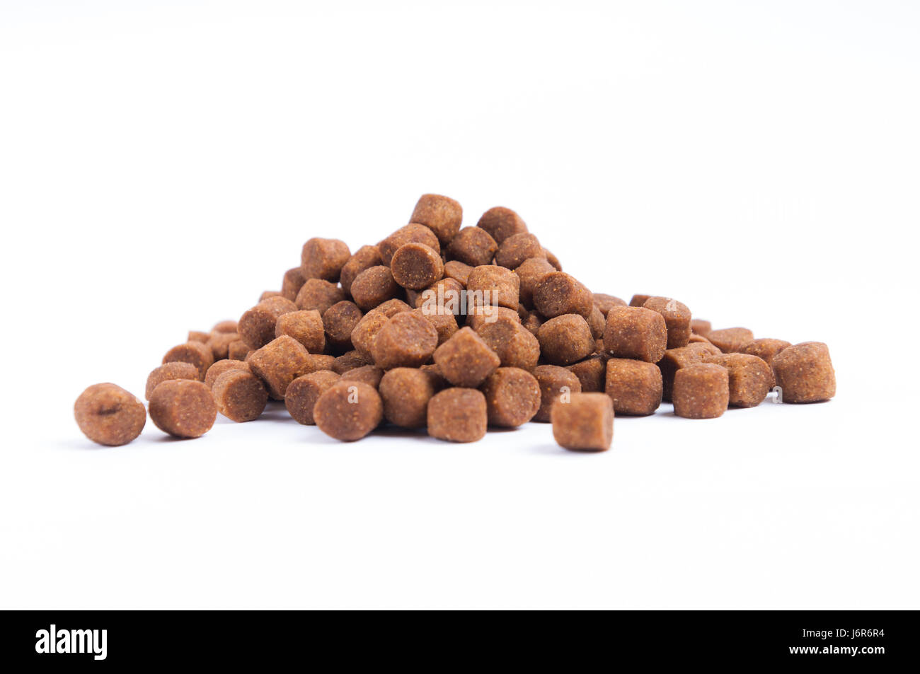 Dry dog food granules isolated on white background Stock Photo - Alamy