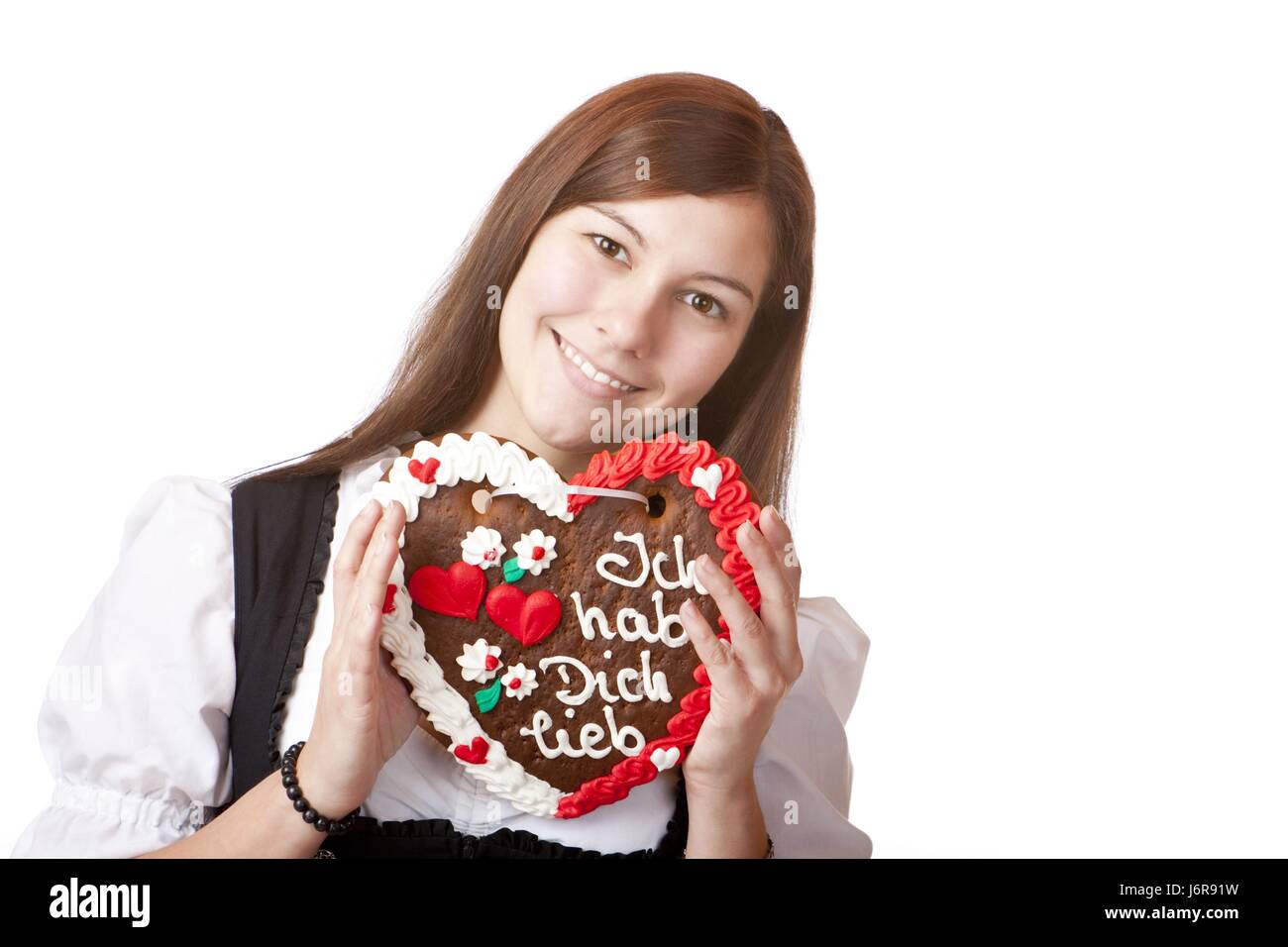woman in dirndl with oktoberfest gingerbread heart Stock Photo - Alamy