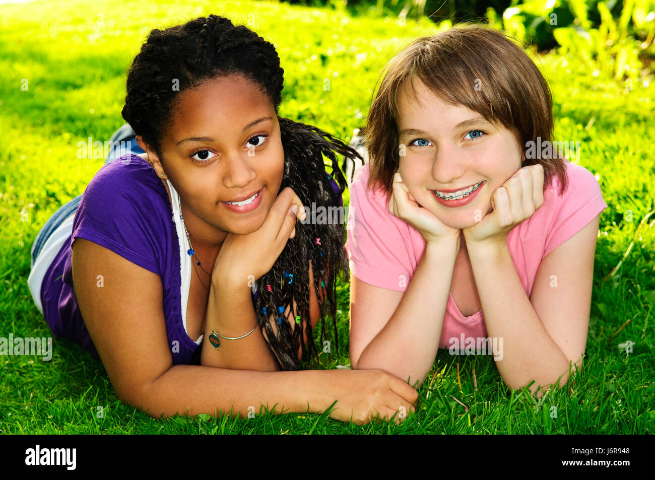 lay meadow grass lawn green girl girls teens teenagers youth two ...