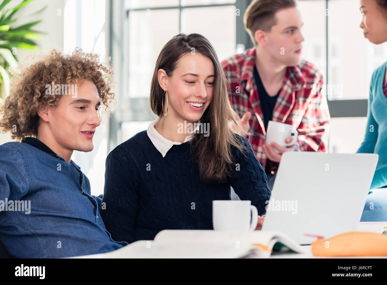 Two young students searching for an answer to their question bot Stock ...