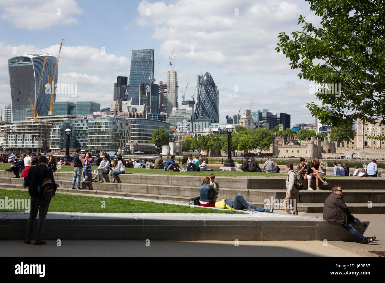 People sunbathing on the grass at the City Park near to Tower Bridge ...