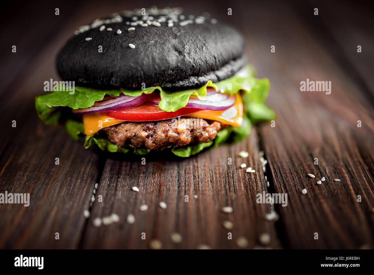 Homemade Black Burger with Cheese. Cheeseburger with black bun on dark ...