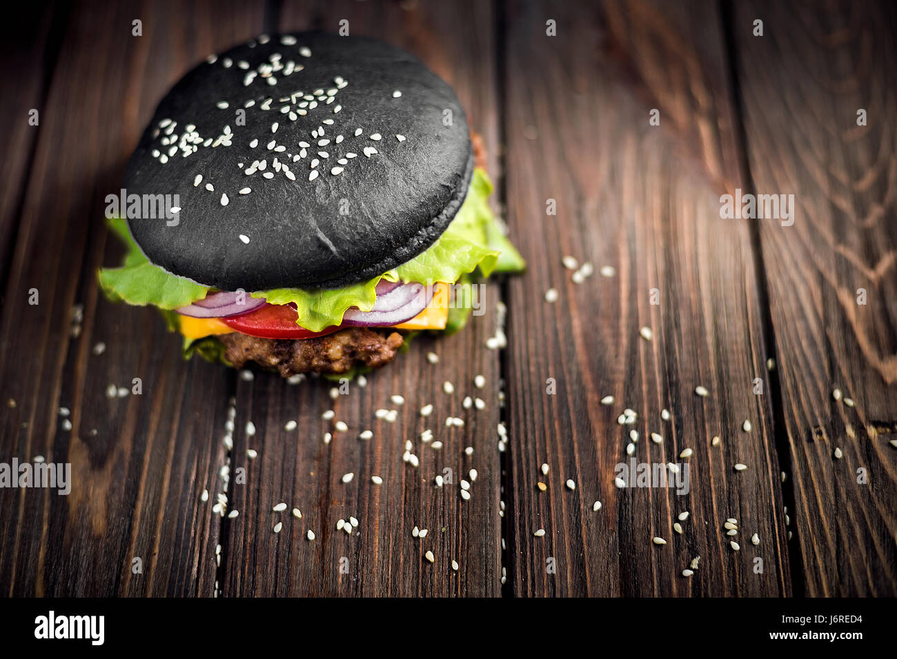 Homemade Black Burger with Cheese. Cheeseburger with black bun on dark ...