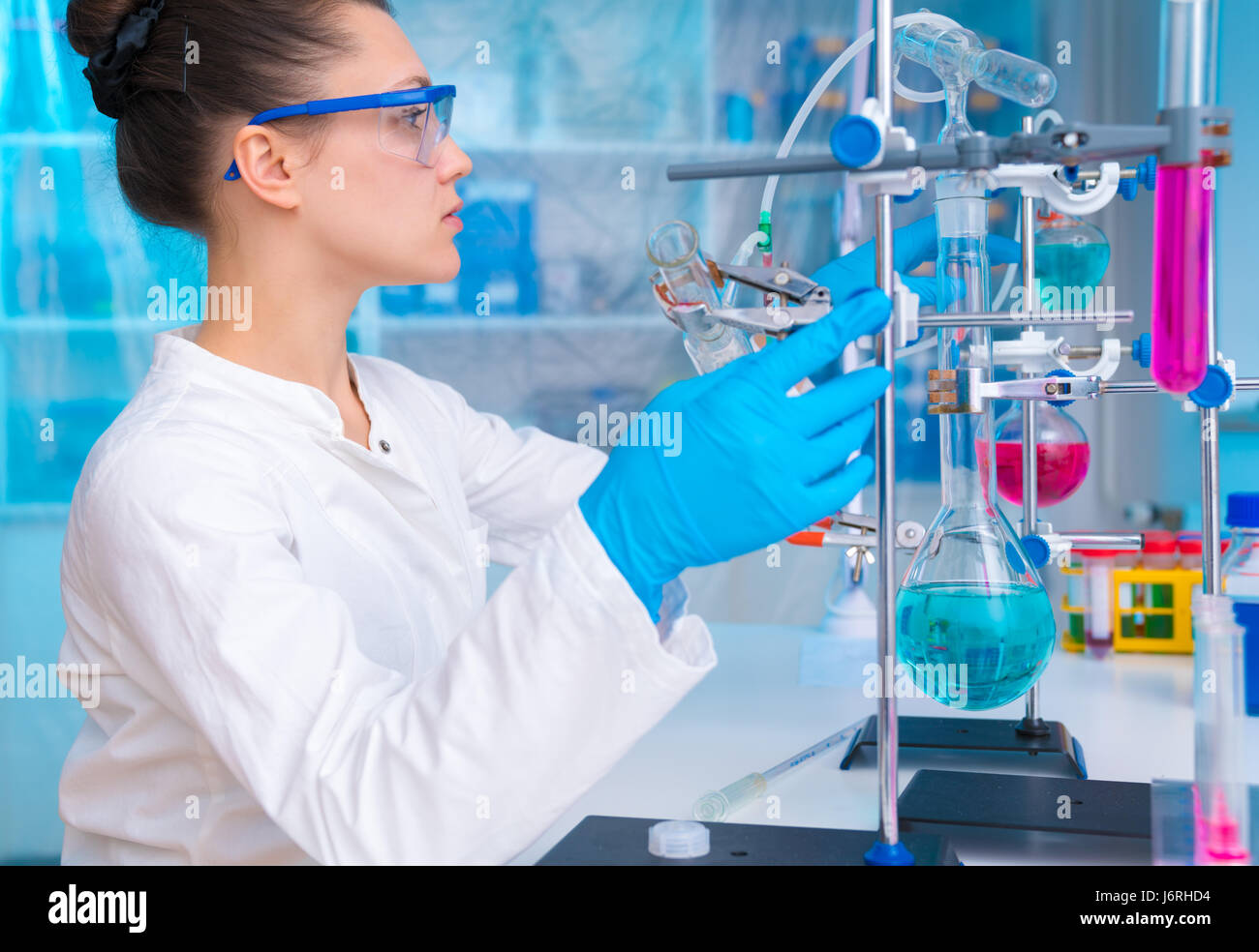 Attractive young female scientist working in laboratory. Woman ...