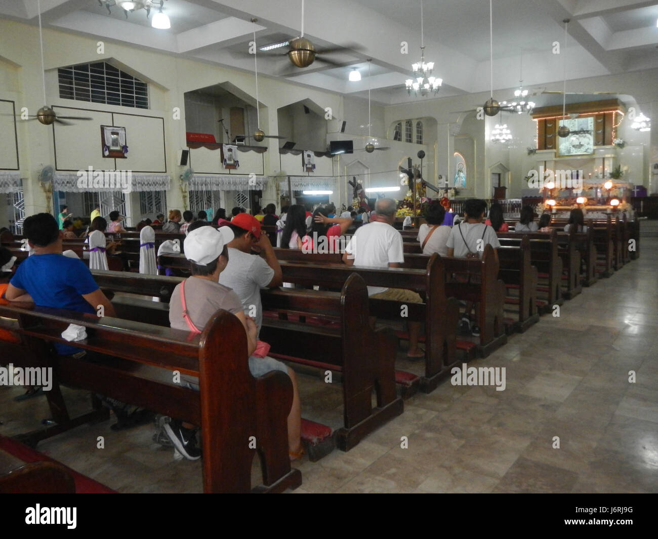 This photograph depicts the Pasyon Pabasa event at the Holy Trinity ...